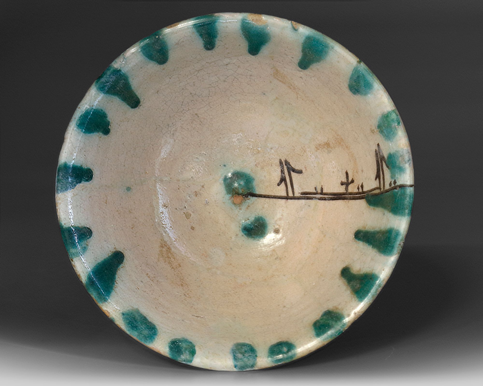 AN ABBASID TIN GLAZED POTTERY BOWL, MESOPOTAMIA, 9TH CENTURY