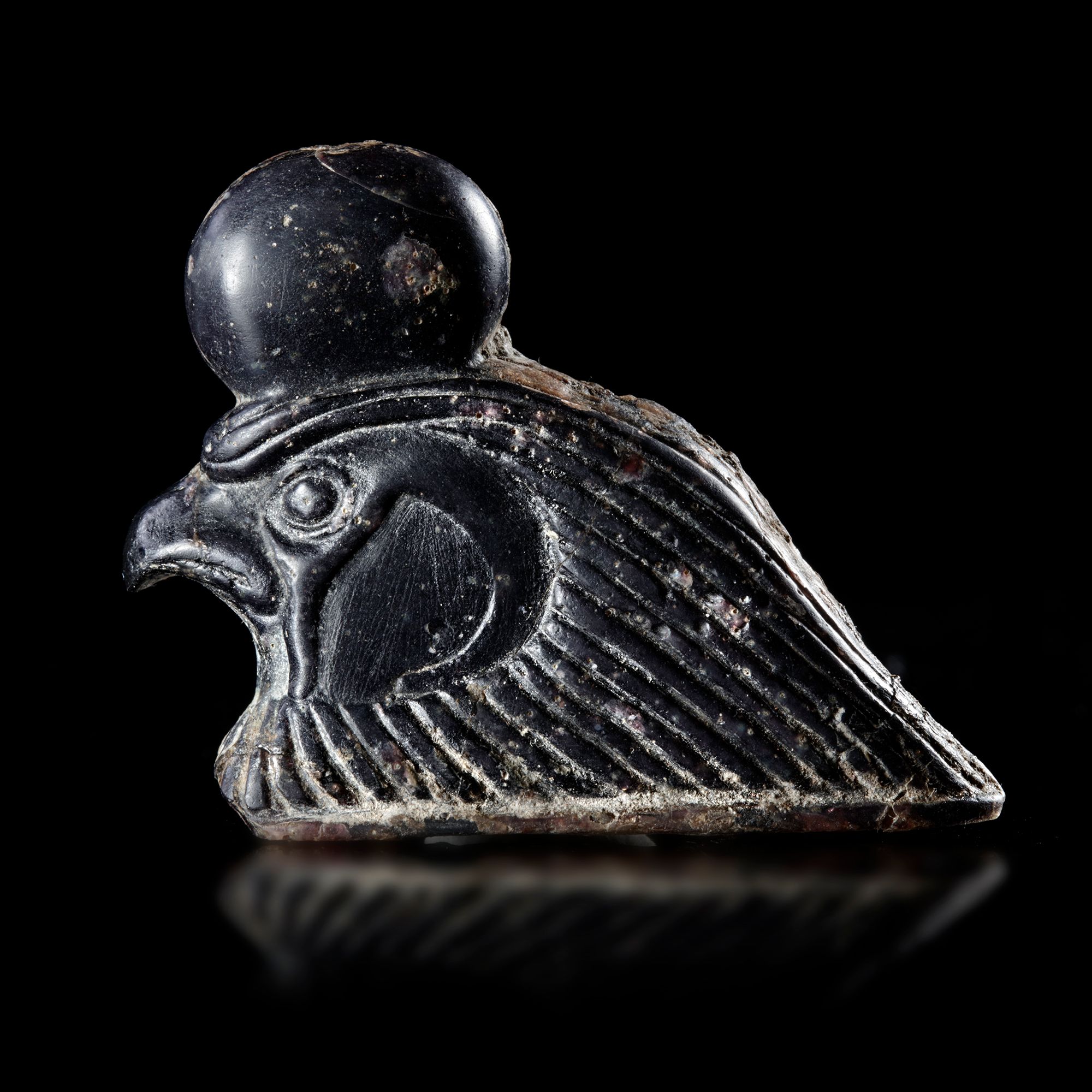 A HEAD OF HORUS IN PROFILE IN BLACK SERPENTINE, LATE PERIOD, 4TH-5TH ...