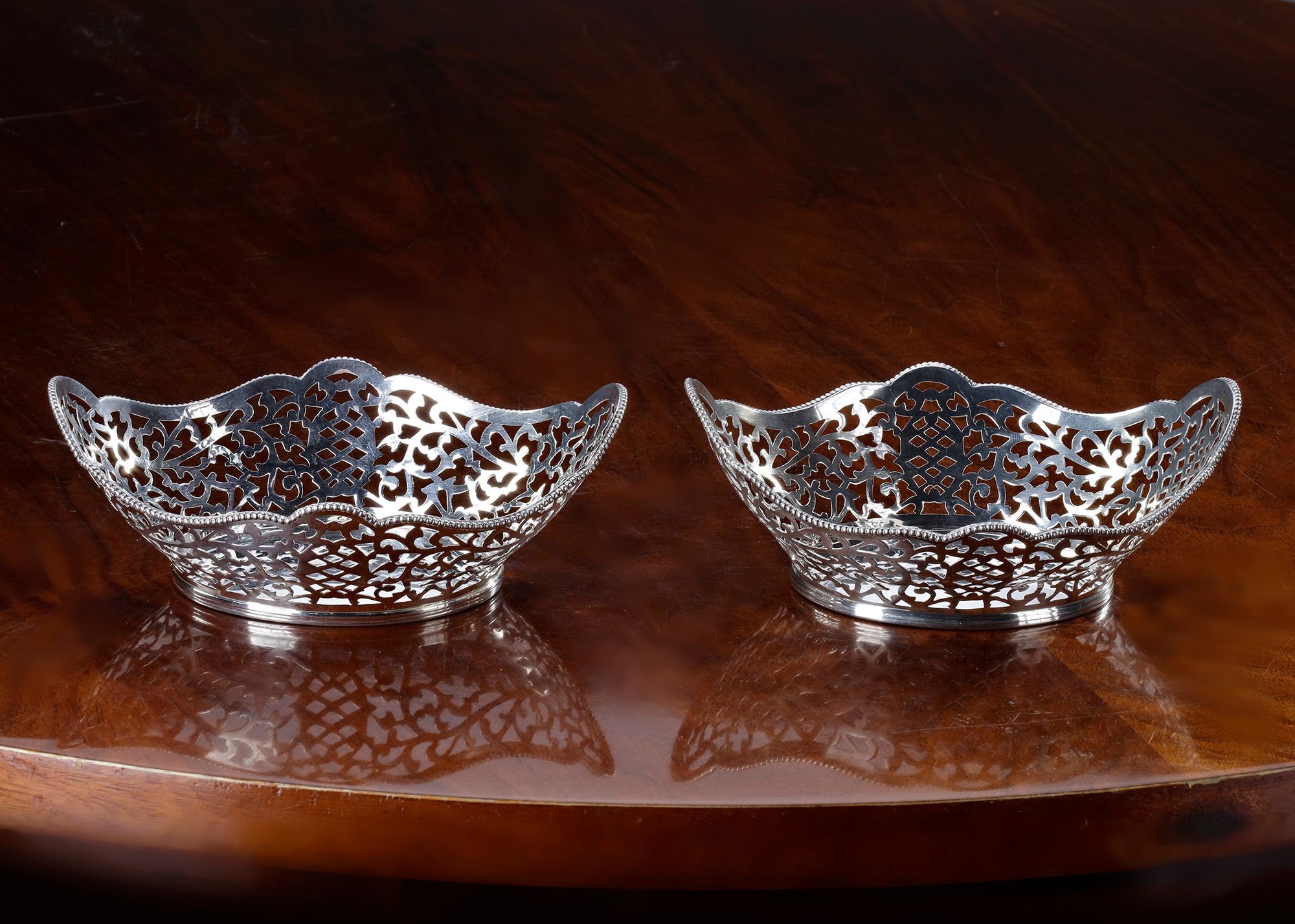 A PAIR OF DUTCH AJOUR CUT SILVER SWEET MEAT BASKETS