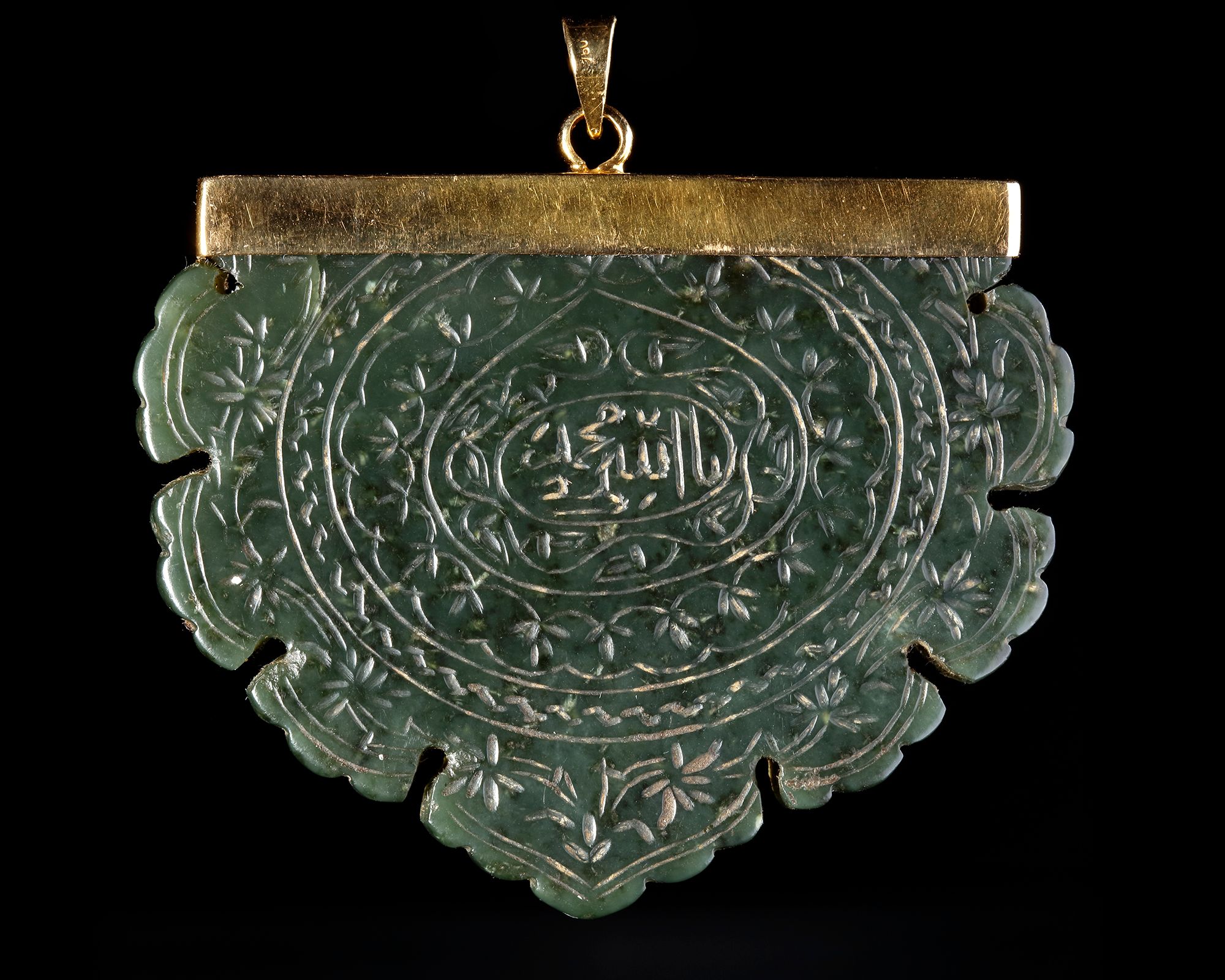A JADE CARVED TALISMANIC PENDANT